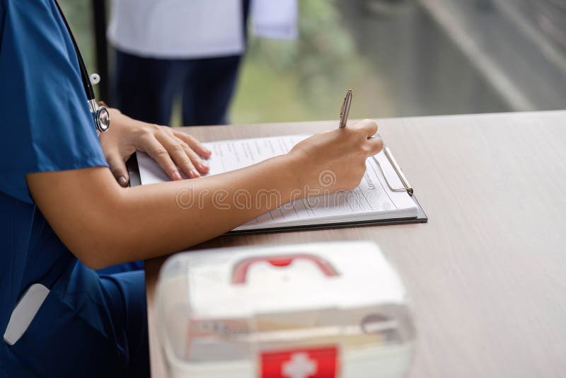 Healthcare Professional Taking Notes Reviewing Patient Data Stock ...
