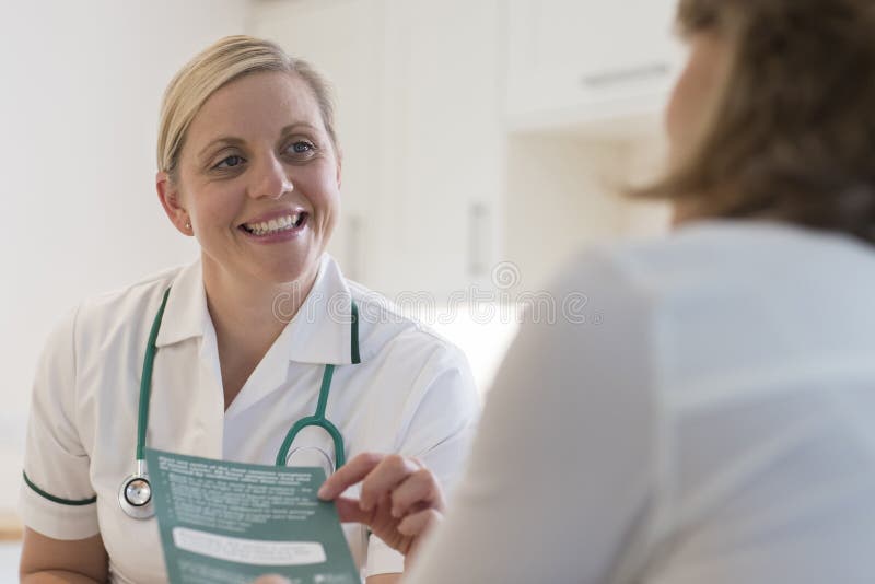 Nurse Discussing Leaflet with Female Patient Stock Image - Image of ...