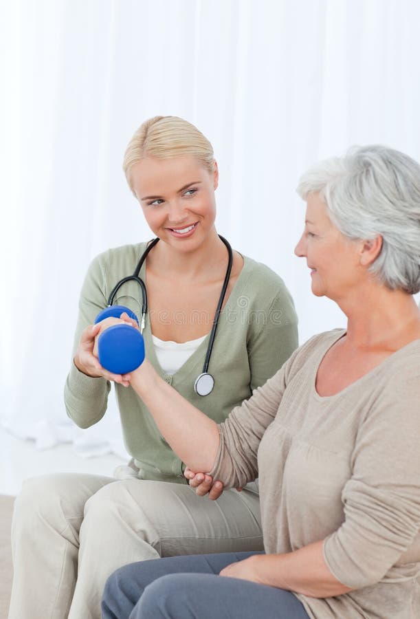Nurse Helping Her Patient To Do Exercises Stock Image - Image of ...