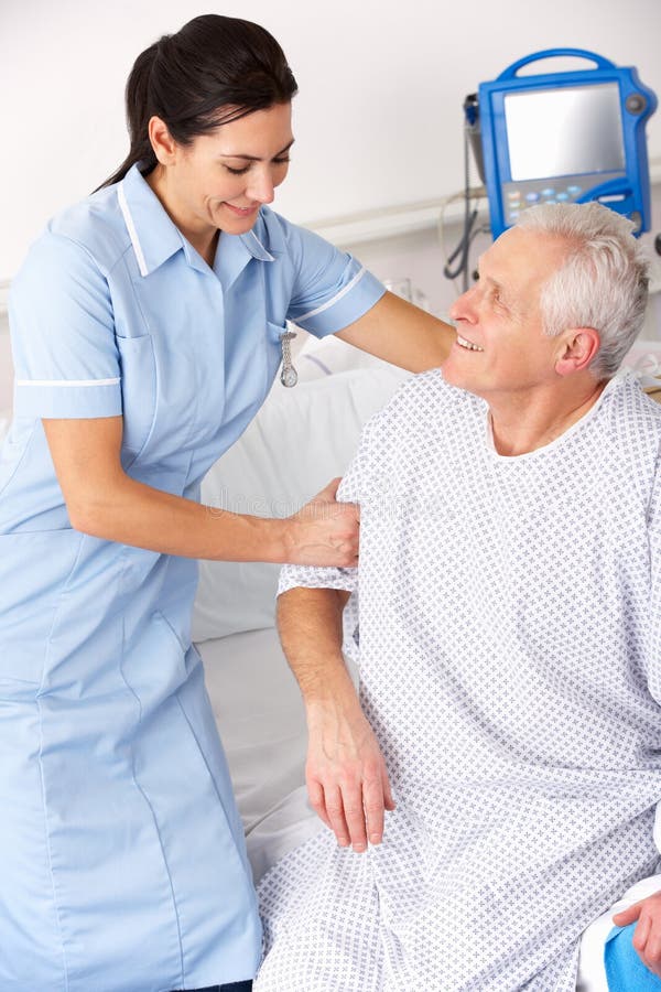 Nurse Helping Patient Sit Up in Bed Stock Photo - Image of adult, color ...