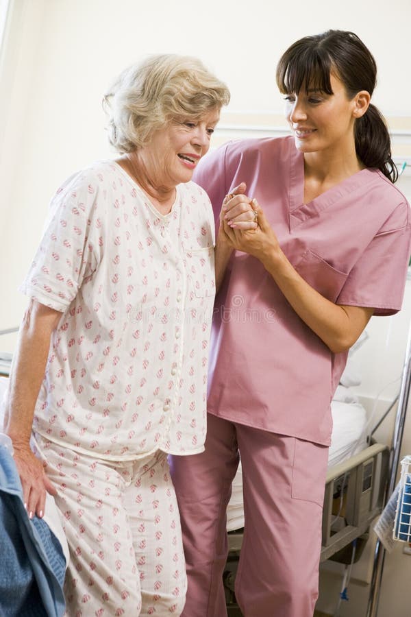 Nurse Helping Senior Woman To Walk Stock Photo - Image of twenties ...