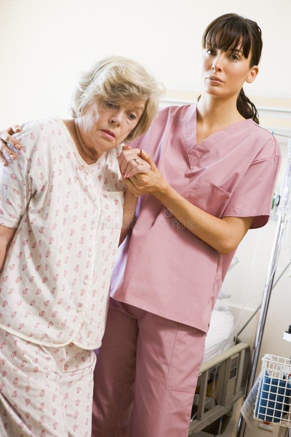 Nurse Helping Senior Woman To Walk Stock Photo - Image of twenties ...