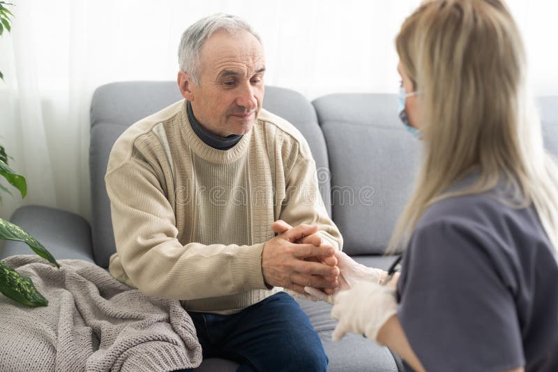 Nurse Holding Hand of Senior Man in Rest Home. Stock Image - Image of ...