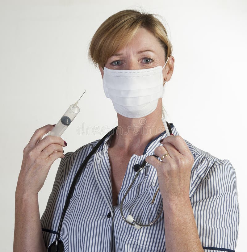 Nurse holding a syringe stock photo. Image of middle - 51682778