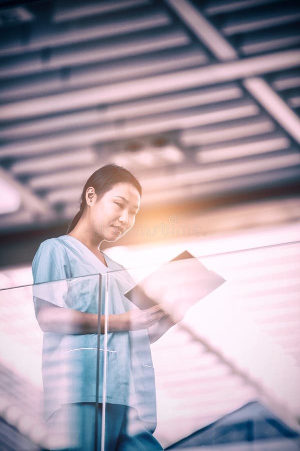 Nurse looking at diary stock photo. Image of focused - 84972304