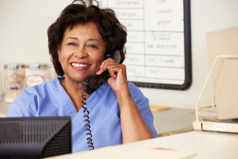 Nurse Making Phone Call at Nurses Station Stock Photo - Image of phone ...