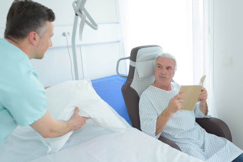 Nurse Next To Patient Reading Book Stock Image - Image of nurse ...