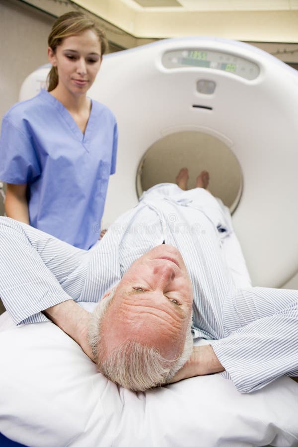 Nurse Monitoring Patient Having CAT Scan Stock Photo - Image of gown ...