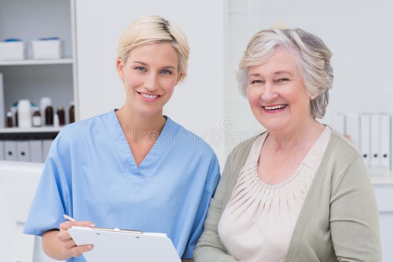 Nurse and Patient Smiling in Clinic Stock Image - Image of camera ...