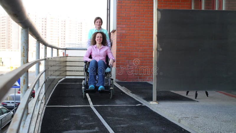 Nurse and Patient in a Wheelchair Go on the Stock Video - Video of ...