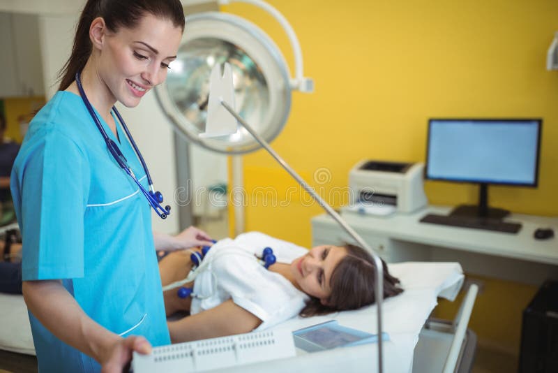 Nurse Performing an Electrocardiogram Test on the Patient Stock Image ...