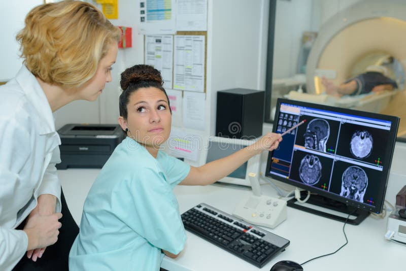 Nurse Pointing at Computer Screen Stock Image - Image of office ...