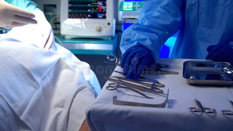 Nurse Providing Surgeon with Tools during Surgery Stock Image - Image ...