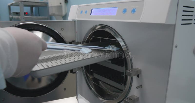 The Nurse Pulls Out a Shelf in the Autoclave and Puts the Wrapped ...