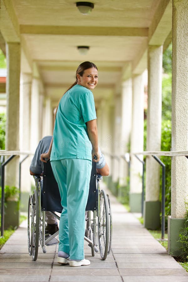 Nurse pushing wheelchair stock photo. Image of help, geriatric - 29235772