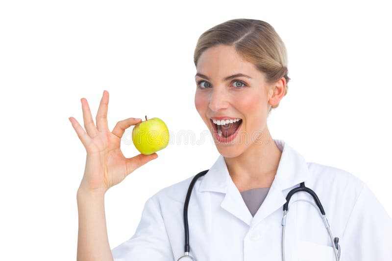 Nurse ready to eat apple stock photo. Image of profession - 31551484