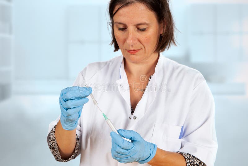 Nurse is Removing Cap from Needle of Syringe Stock Image - Image of ...