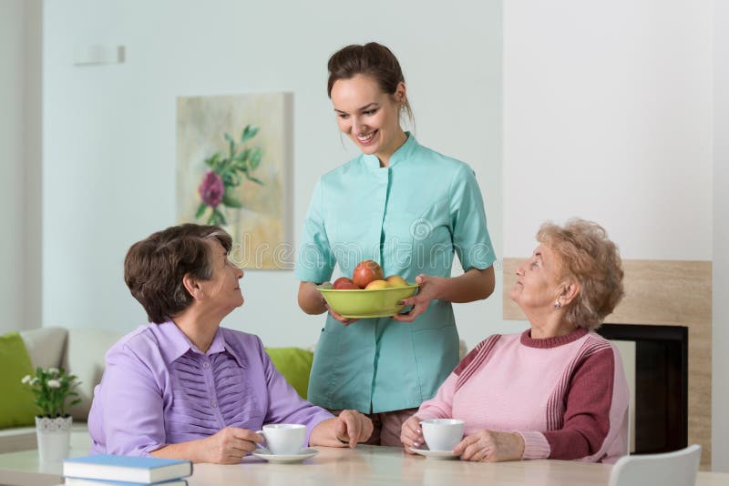 Nurse Serving Tea and Snacks Stock Photo - Image of friends, joyful ...