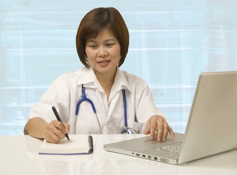 Nurse sitting at her desk stock photo. Image of attractive - 14949062