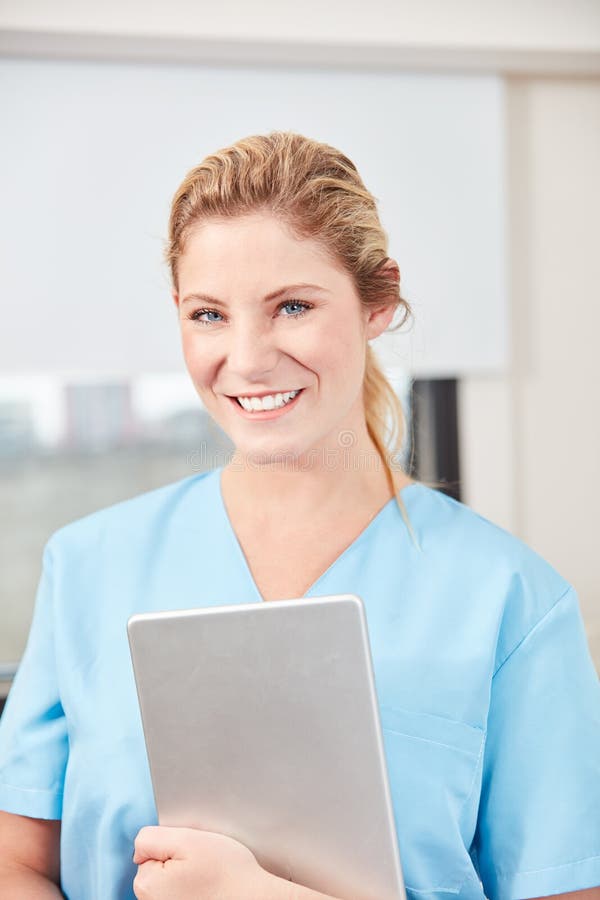 Nurse with tablet computer stock image. Image of extended - 135679523