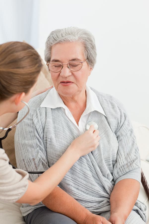 Nurse Taking the Heartbeat of Her Patient Stock Photo - Image of ...