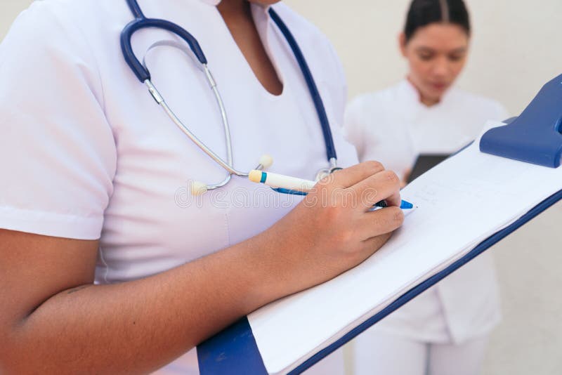 Nurse Taking Notes of a Patient in the Hospital Stock Photo - Image of ...