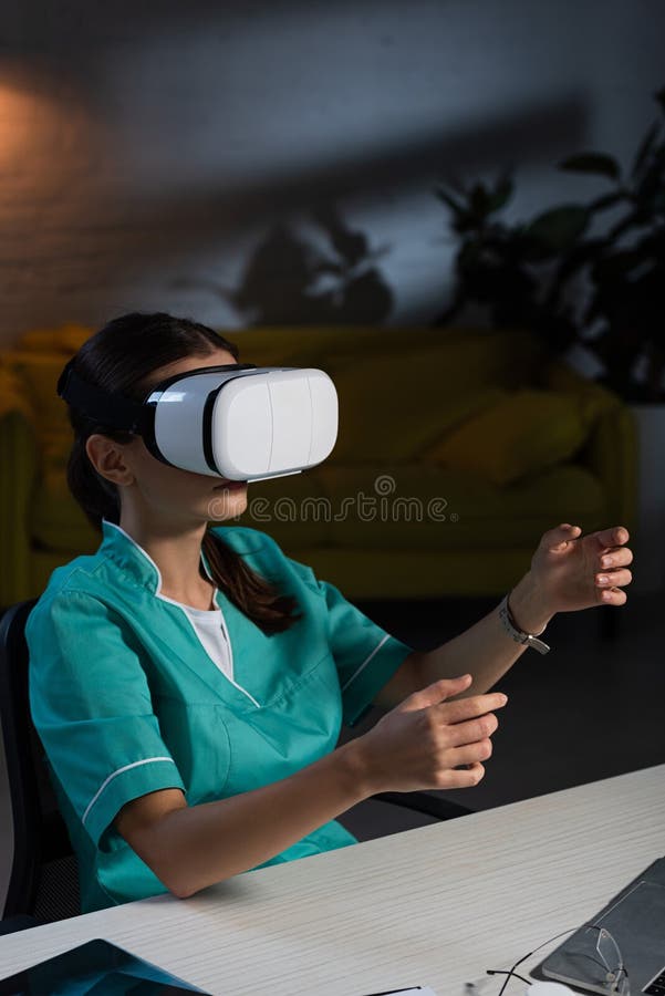 Nurse in Uniform Sitting at Table with Virtual Reality Headset Stock ...