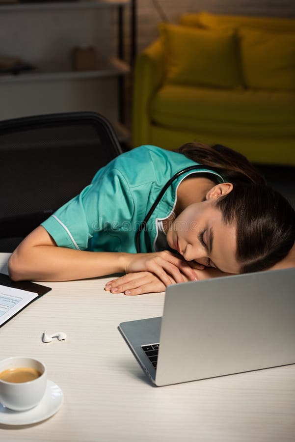 Nurse in Uniform Sleeping on Table Stock Photo - Image of laptop ...