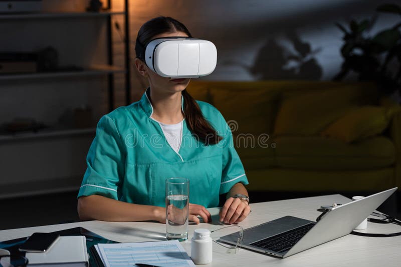 Nurse in Uniform with Virtual Reality Headset Sitting at Table Stock ...