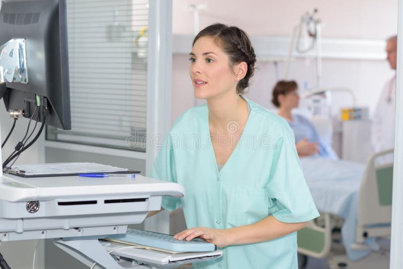 Nurse Using Computer Outside Patient`s Room Stock Image - Image of ...