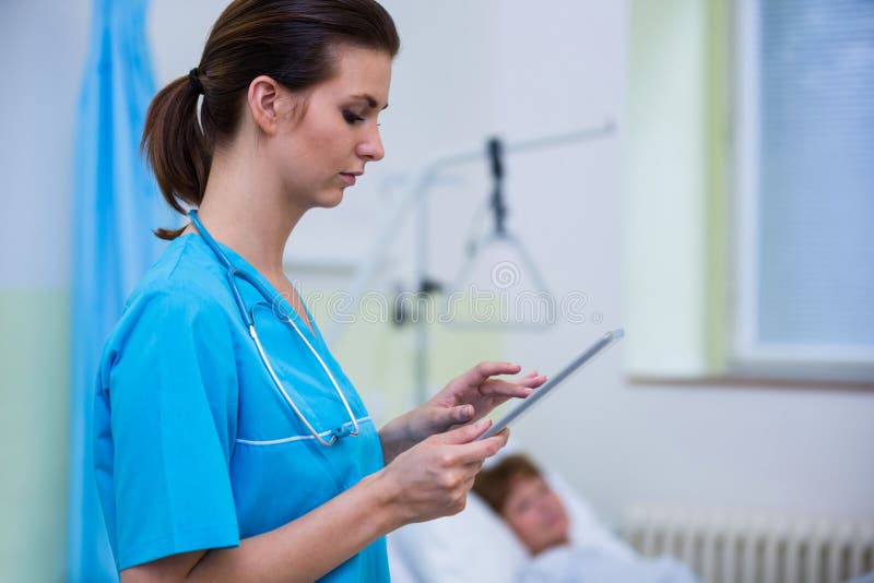Nurse Using Digital Tablet in Hospital Ward Stock Image - Image of ...
