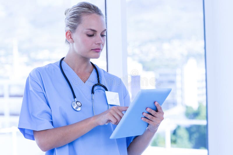 Nurse using her tablet pc stock image. Image of expertise - 54249417