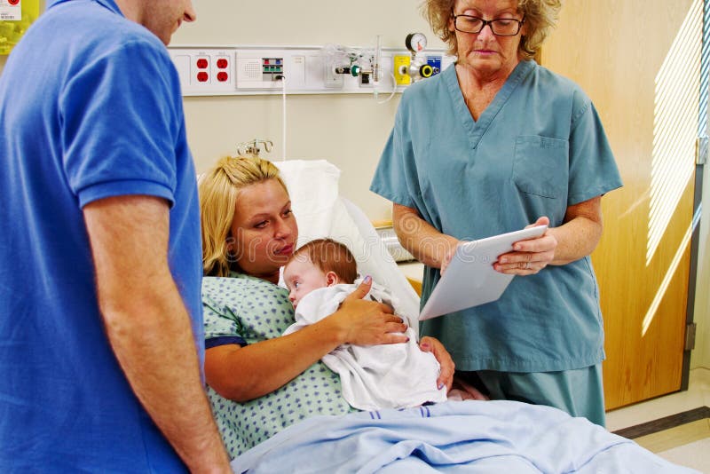 Nurse Using Tablet To Give Instructions To Parents Stock Image - Image ...