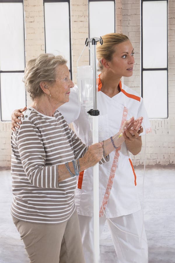 Nurse Walking Next To A Patient With IV Drip Stock Photo - Image of ...