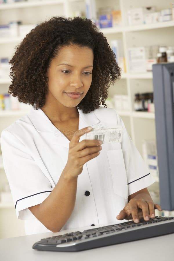 Pharmacist with Laptop Computer and Medication in the Pharmacy Stock ...