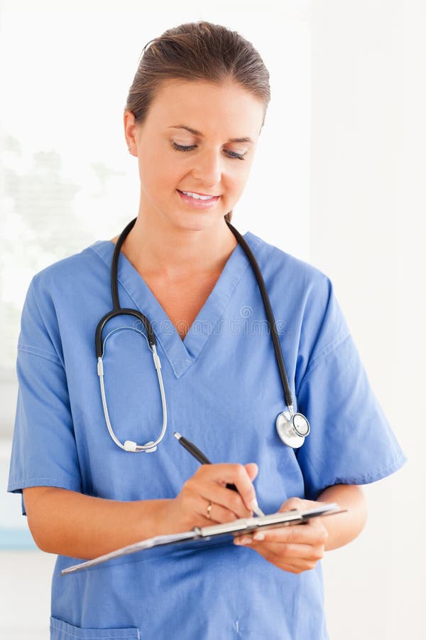 Nurse Writing in a Folder with a Pen Stock Image - Image of clinical ...