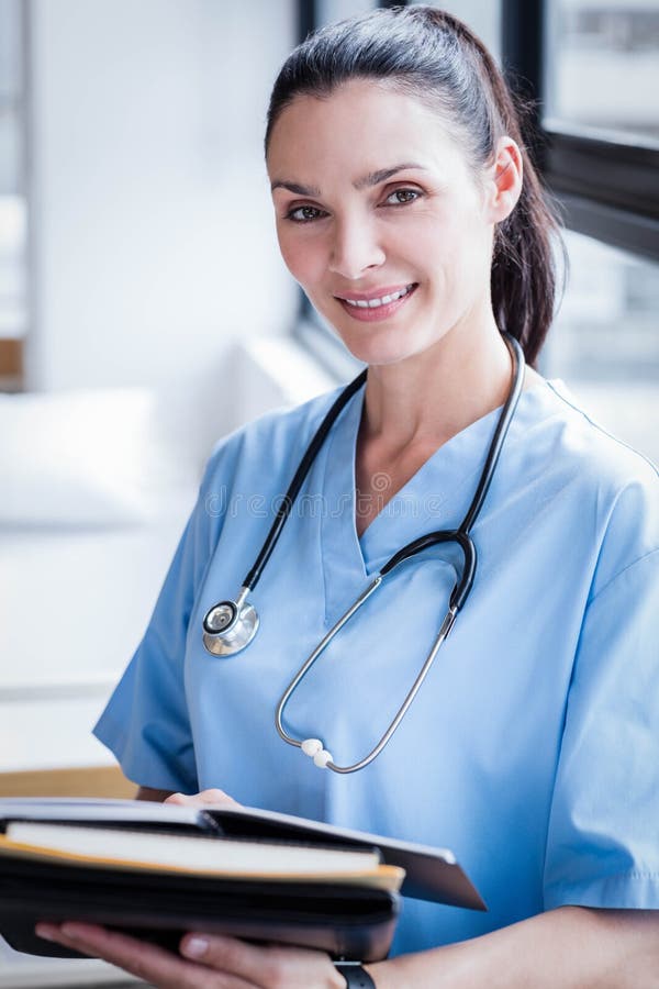 Nurse writing in her diary stock photo. Image of office - 66435050