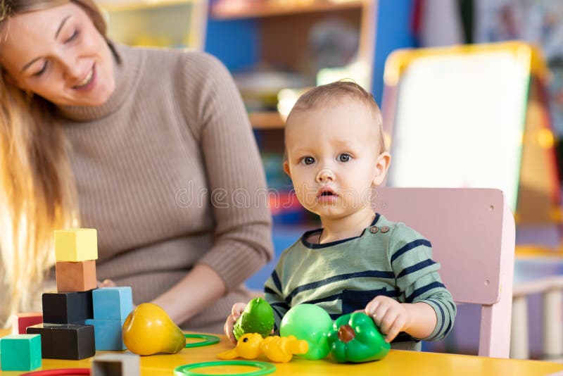 Nursery Child Playing With Teacher In The Classroom Stock Image - Image ...