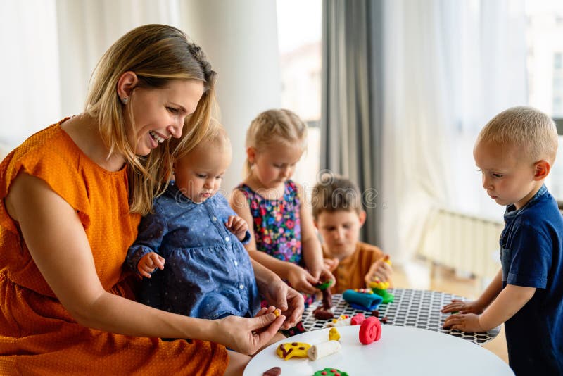Nursery Children Having Fun and Playing with Teachers. Stock Photo ...