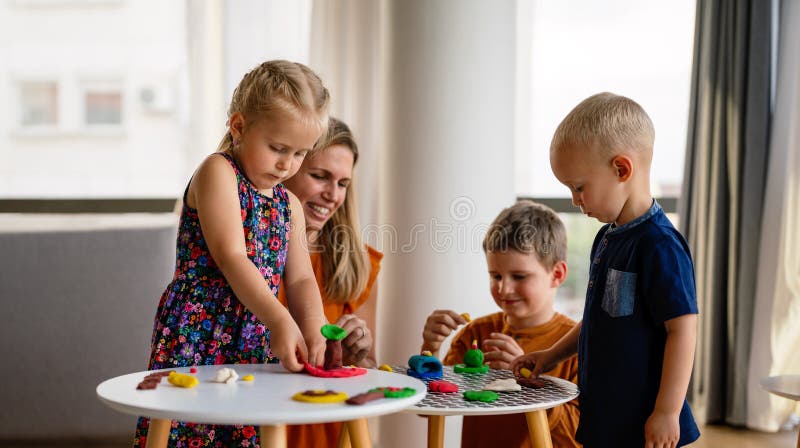 Nursery Children Having Fun and Playing with Teachers. Stock Photo ...