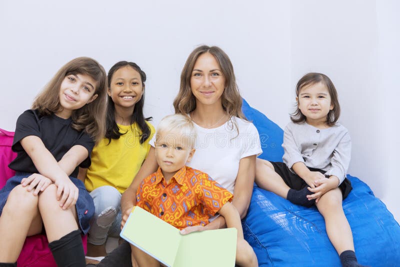 Nursery Teacher Sitting with a Group of Kids Stock Image - Image of ...