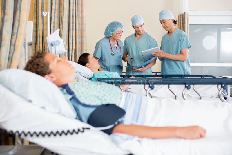 Nurses Discussing Patient S Chart Post Surgery Stock Photo - Image of ...