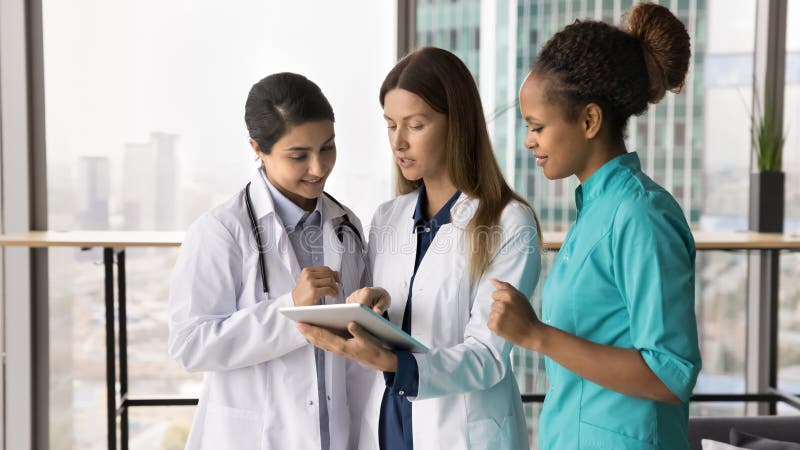 Nurses and GP Professional Using Tablet at Workplace Stock Image ...
