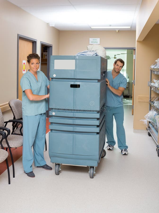 Nurses Pushing Trolley in Hospital Hallway Stock Image - Image of ...