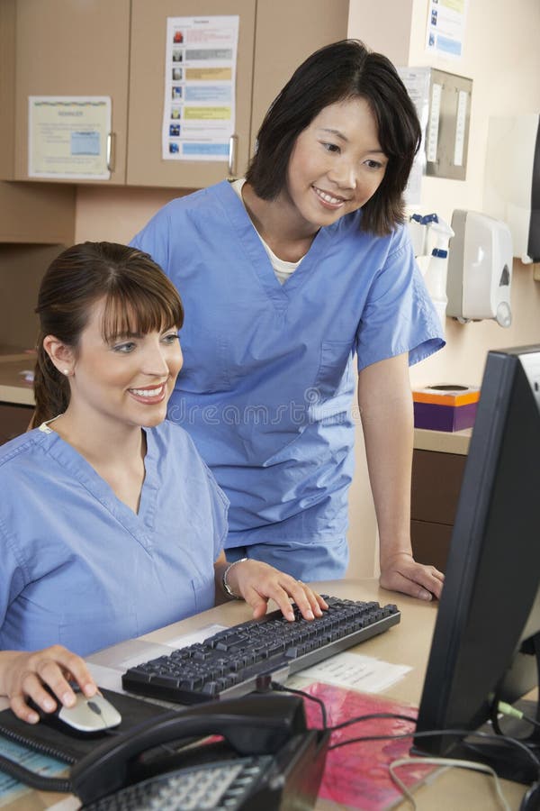 Portrait of Male Nurse Working at Nurses Station Stock Image - Image of ...