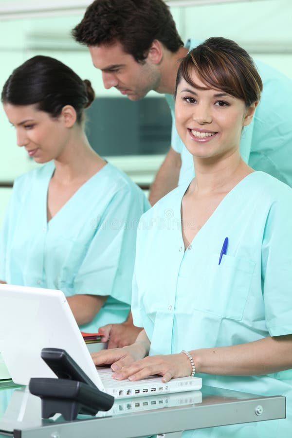Portrait of Female Nurse Working at Nurses Station Stock Photo - Image ...