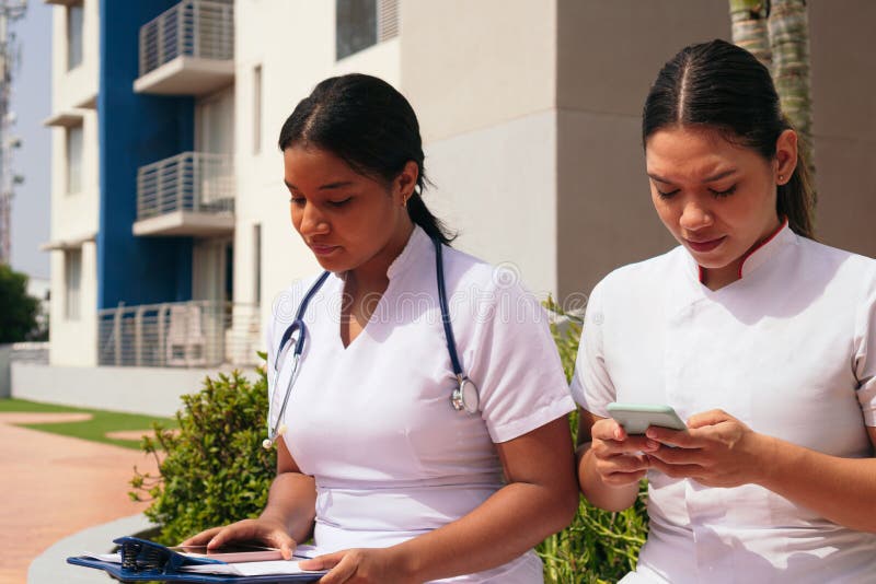 Nurses Watching Their Phone Outside the Hospital Stock Image - Image of ...