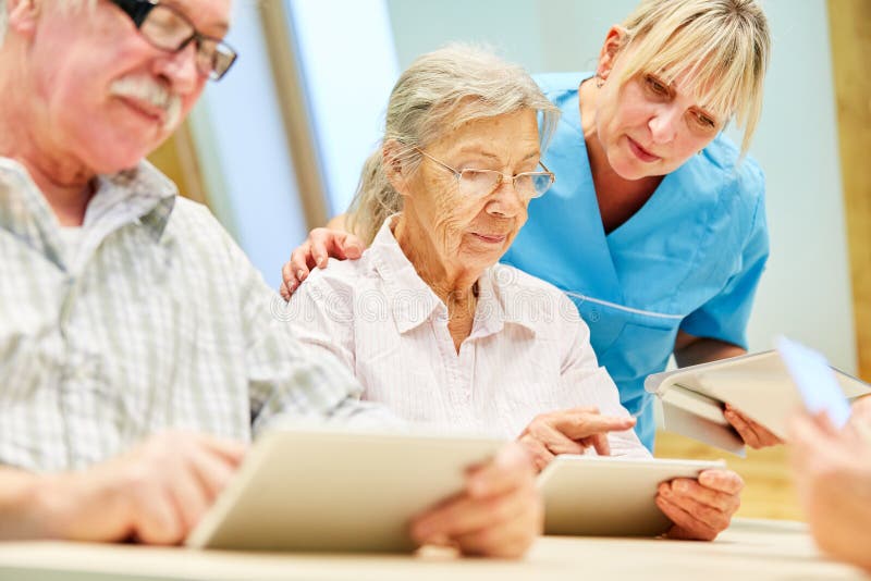 Nursing Assistance Looks after Seniors in the Computer Course Stock ...