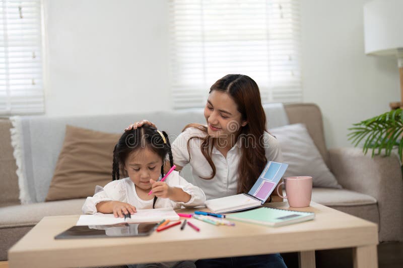 Nurturing and Focused Learning. a Mother Supports Her Daughters ...