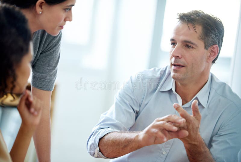 Nurturing His New Staff. a Group of Coworkers Having a Discussion in ...